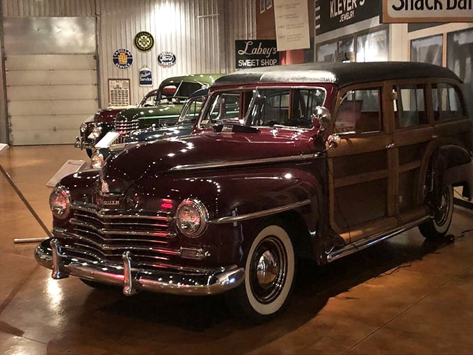 This burgundy Plymouth woody wagon isn't just transportation—it's a mahogany-trimmed time machine ready to carry your family to a 1940s beach picnic.