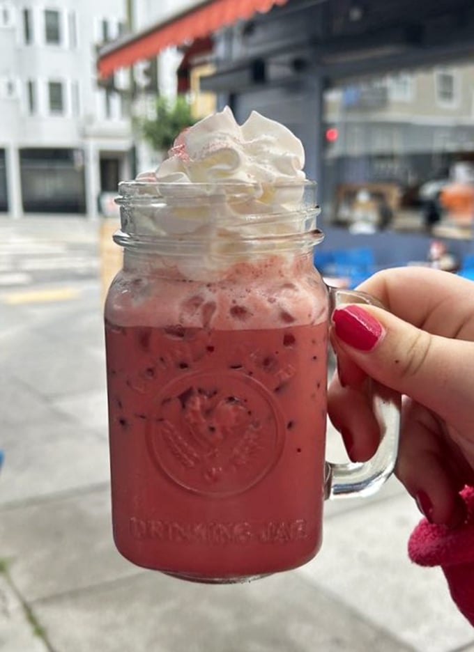 A mason jar of ruby-red refreshment topped with clouds of whipped cream – because sometimes breakfast calls for something beyond the coffee spectrum.