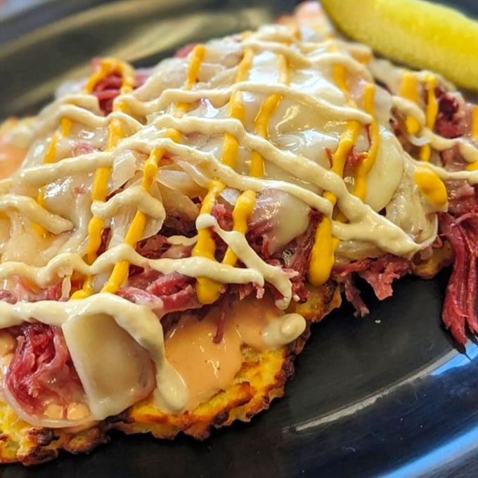 The Reuben potato pancake defies categorization and gravity—a magnificent tower of corned beef, sauerkraut, and cheese that would make both Cleveland and New York proud.