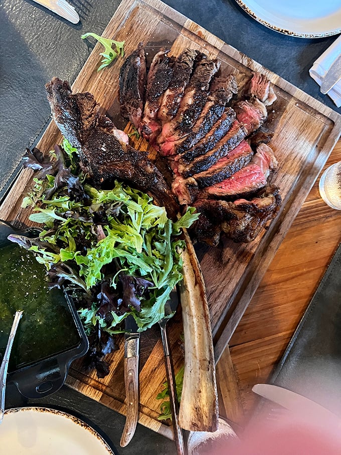 A ribeye so perfectly sliced it could teach geometry classes, with a side of greens to pretend you're eating healthy.