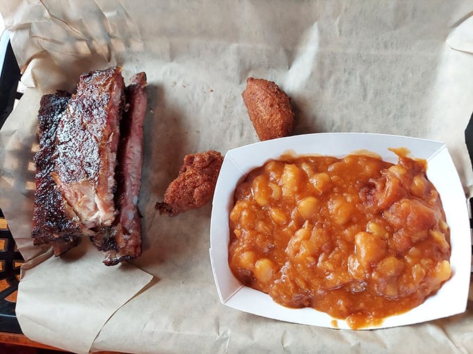 Poetry on a plate: smoky ribs alongside beans that have clearly been simmering since before your morning alarm went off.