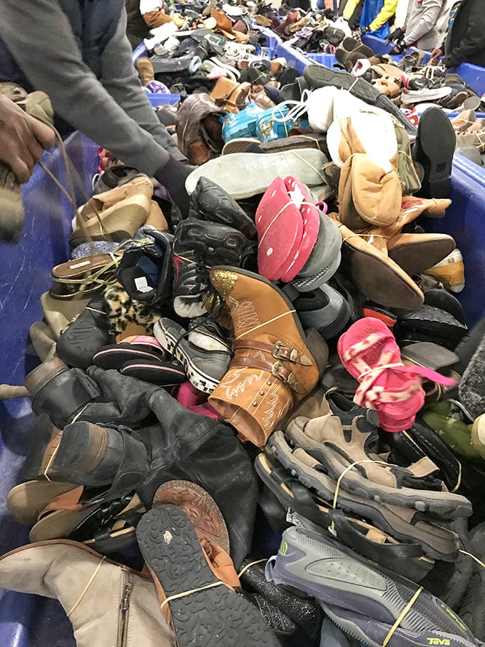 The footwear bin resembles a surrealist sculpture—hundreds of single shoes hoping to reunite with their partners in shopper paradise. 