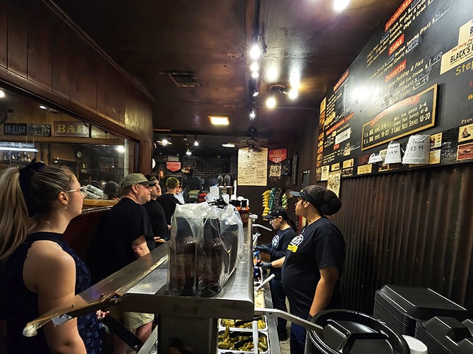 The line moves with practiced efficiency—a barbecue ballet where patience is rewarded with meat that makes waiting feel like the smartest decision you've made all week.