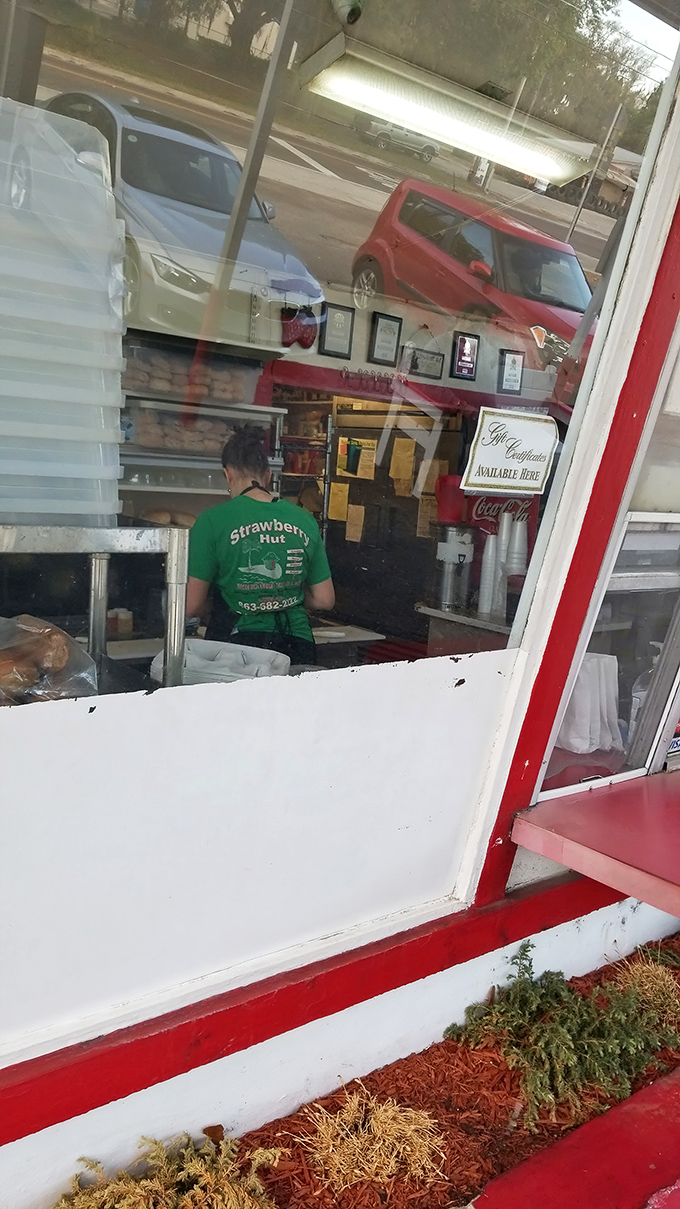 Behind every great sandwich is someone in a green shirt working magic. The sandwich artist at work deserves our silent appreciation.