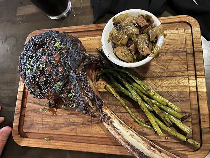 The Tomahawk—part steak, part conversation piece, all delicious. This primal cut makes vegetarians reconsider their life choices.
