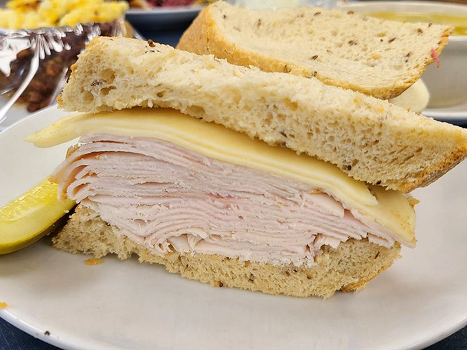 This turkey sandwich isn't playing games—layer upon layer of thinly sliced meat with cheese on fresh-baked bread that puts sad desk lunches everywhere to shame.