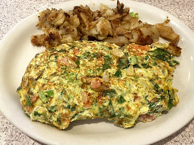 An omelet that's not afraid to show its personality. Packed with veggies and paired with those perfectly crisped potatoes—breakfast doesn't get more honest than this.