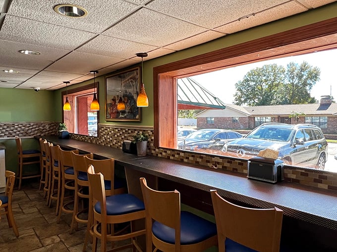 Counter seating with a view – where solo diners become regulars and the outside world provides free entertainment with every meal.
