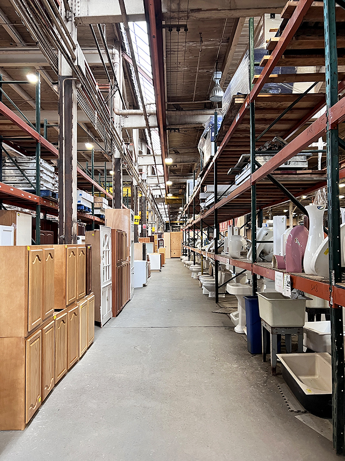 Architectural salvation lines this aisle, where bathroom fixtures and cabinet doors stand at attention, awaiting their second act in someone's renovation story.