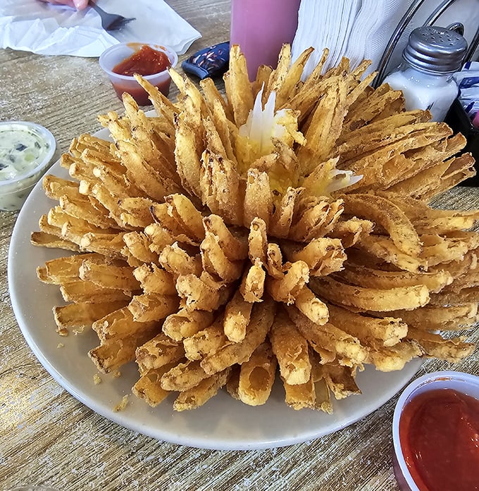 The Bloomin' Onion's sophisticated cousin has arrived—a golden sunburst of crispy onion rings that demands to be shared but deserves to be hoarded.