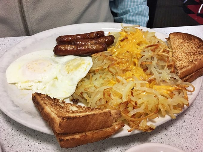 The breakfast trinity – sausage links, sunny-side up eggs, and hash browns with cheese that would make even non-morning people set an alarm.