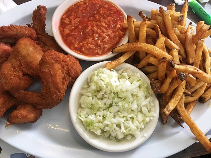 A plate that says "diet starts tomorrow" in the most delicious way possible—crispy wings, fresh-cut fries, and those essential sides.