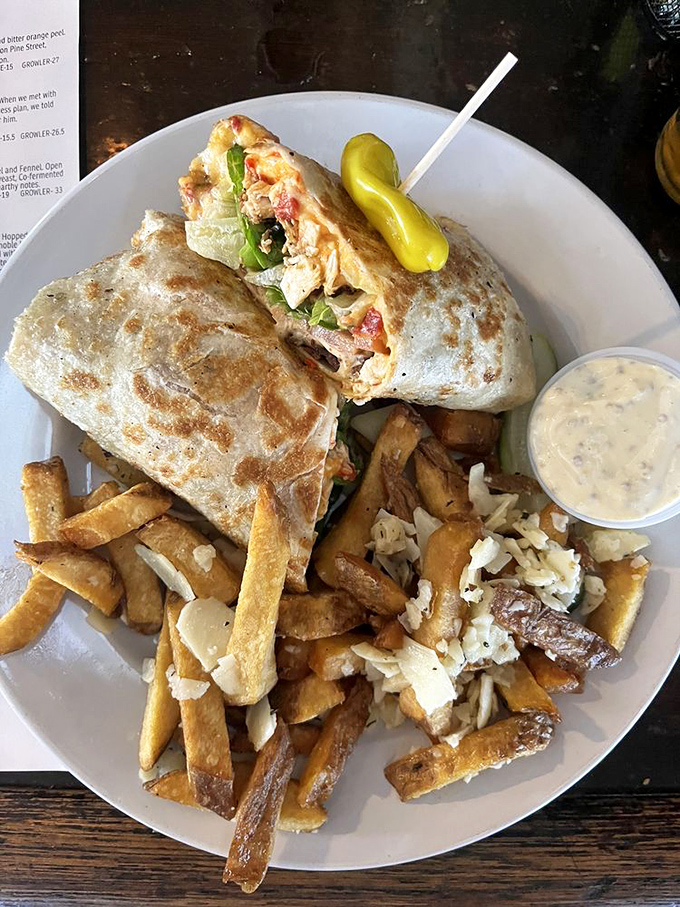This isn't just a wrap—it's a carefully constructed flavor bomb with crispy fries standing guard alongside, ready for dipping duty.