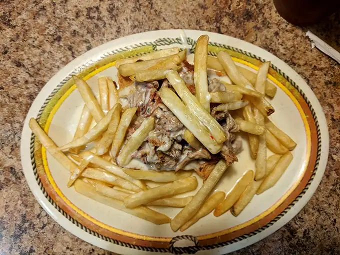 Fries ascend to their highest calling when topped with pulled pork—a culinary promotion from side dish to main event.