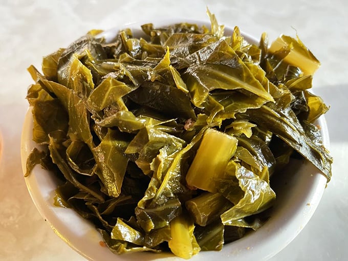 Collard greens that have clearly been cooked with respect—tender, flavorful, and making you feel slightly virtuous amid barbecue indulgence.