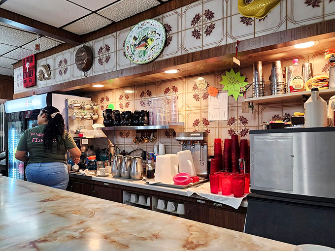 The counter area—where breakfast magic happens. That vintage tile backsplash has witnessed more morning revelations than a therapist's couch.