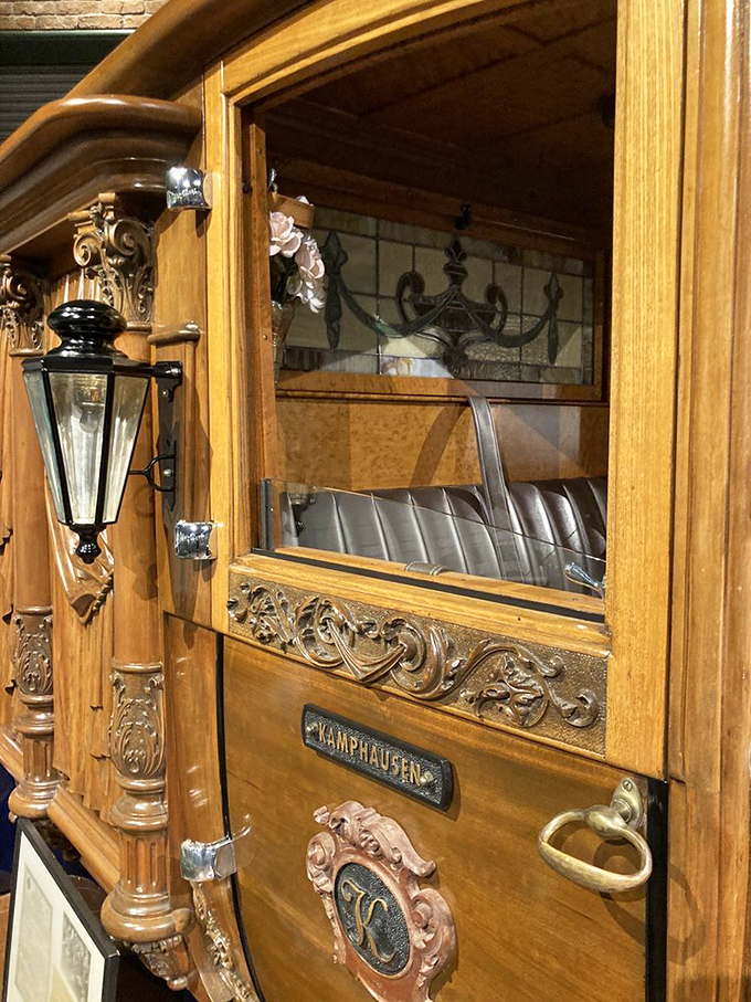 The craftsmanship on this 1921 hearse's wooden cabin rivals fine furniture—ornate carvings and brass fixtures showcase an era when functional objects were also beautiful.