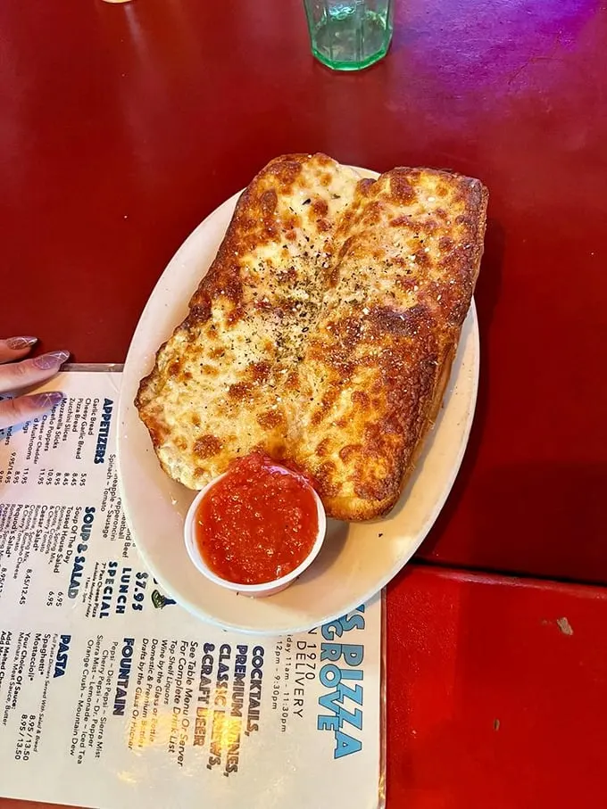 Garlic bread that's achieved the perfect golden ratio of crisp exterior to pillowy interior. The side of marinara isn't optional—it's essential.