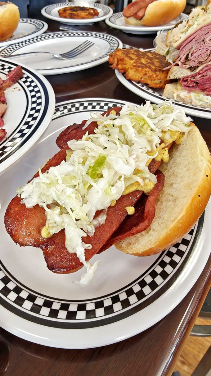 Hot dogs ascend to art form when crowned with crisp cabbage and mustard—proof that sometimes the simplest pleasures deliver the deepest satisfaction.