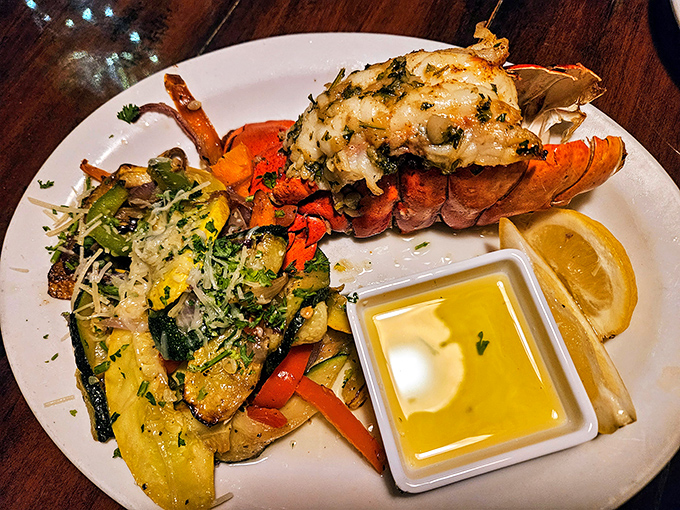 This lobster tail isn't just dinner—it's a crustacean celebration atop a colorful medley of vegetables that brighten the plate and the palate.