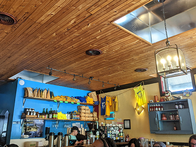 The blue wall shelf displays merchandise and supplies—like a treasure trove of breakfast possibilities waiting to happen.
