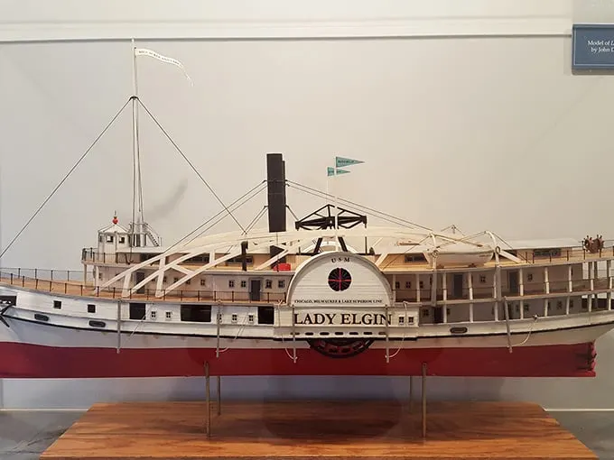 The Lady Elgin model serves as a somber reminder of the 1860 shipwreck that claimed 300 lives and spurred the lighthouse's construction.