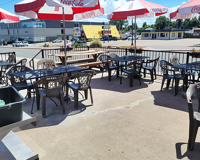 Outdoor seating under classic Coca-Cola umbrellas—because sometimes you need fresh air with your comfort food and a view of everyday America.