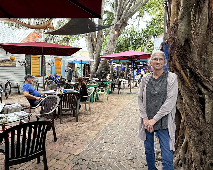 Outdoor dining under the dappled shade of tropical trees—nature's dining room where every table feels like the best seat in the house.