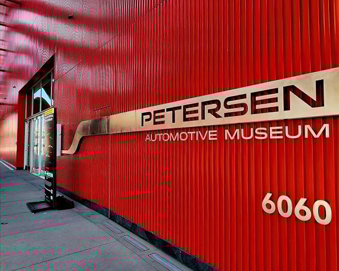 That crimson exterior with the museum's name emblazoned across it—automotive Mecca announcing itself to Wilshire Boulevard pilgrims.
