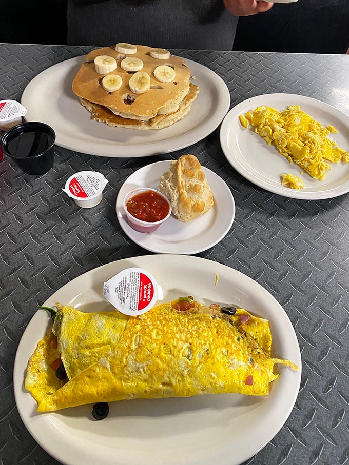 The breakfast trinity: golden pancakes, fluffy eggs, and a biscuit with jam. Simplicity that somehow manages to be revolutionary.