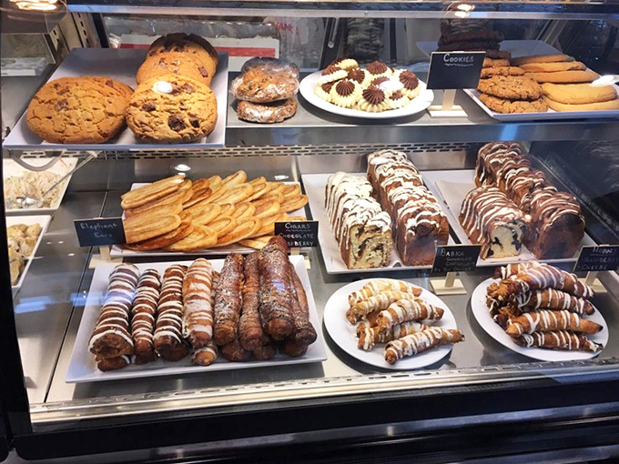 The pastry case—where willpower goes to die and diet plans are forgotten. Each item whispers, "Just this once won't hurt."