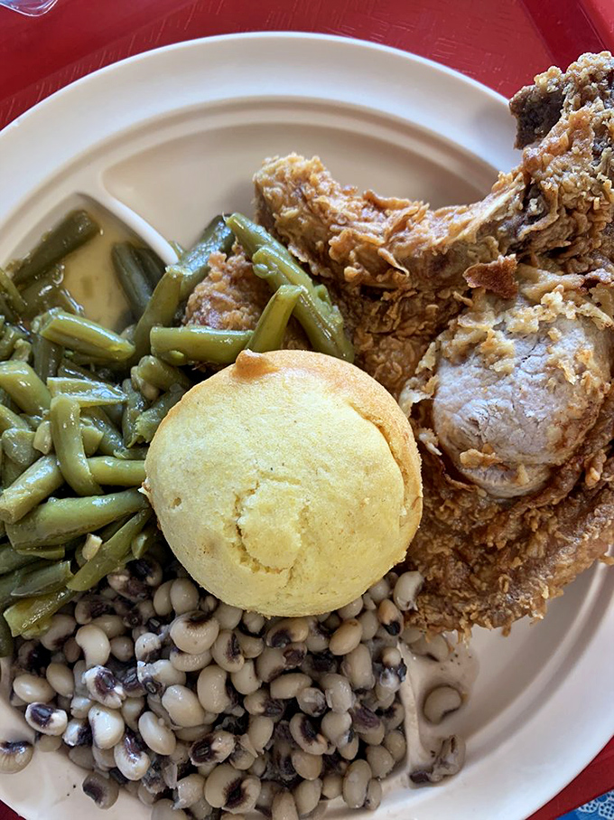 This isn't just fried chicken—it's a masterclass in crunch, served with green beans that have clearly been on speaking terms with bacon.