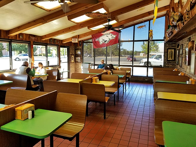 Green tabletops, wooden booths, and Arkansas Razorback pride—a dining room where conversations flow as freely as the sweet tea.