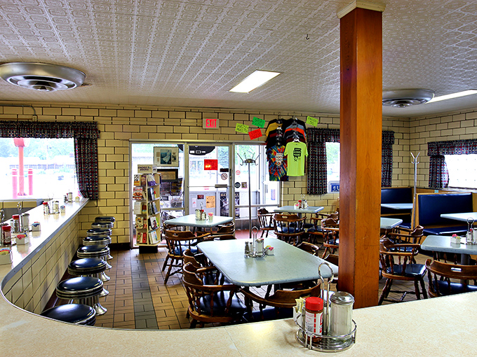 Classic diner seating with a view of the counter action. Those wooden chairs have supported generations of Toledo residents through countless cups of coffee and slices of pie.
