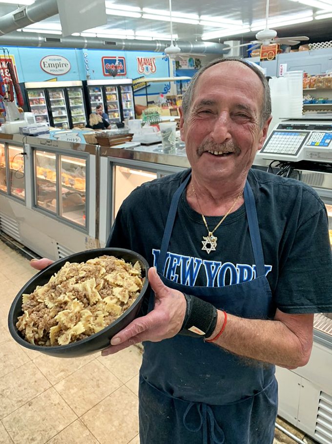 Behind every great deli is someone who knows their kugel from their knish. That smile says you're about to taste something special.