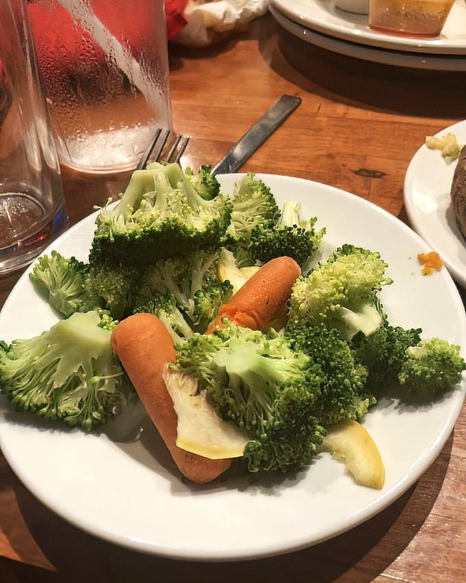 Proof that vegetables aren't just an afterthought – these vibrant steamed broccoli florets and carrots provide a welcome counterpoint to protein indulgence.