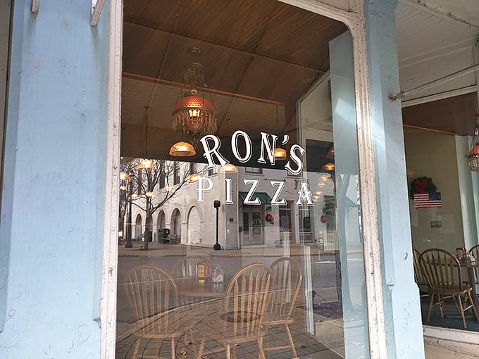 Wooden chairs visible through Ron's windows promise the comfort of simplicity – where nothing distracts from perfect pizza pleasure.