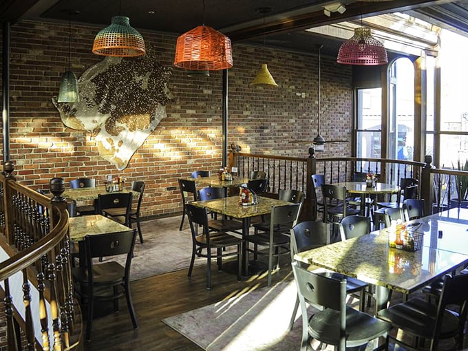 Dining with altitude—colorful pendant lights and exposed brick create the perfect backdrop for food that deserves a stage.