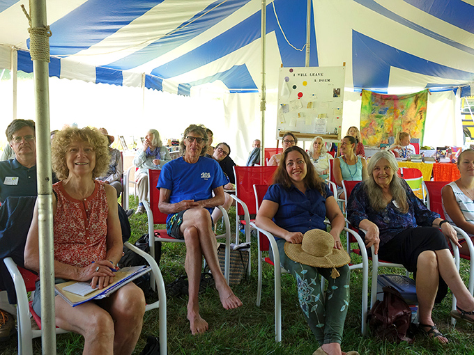 Community gathers under blue and white stripes, proving Floyd's artistic spirit extends beyond music to celebrate the power of words.