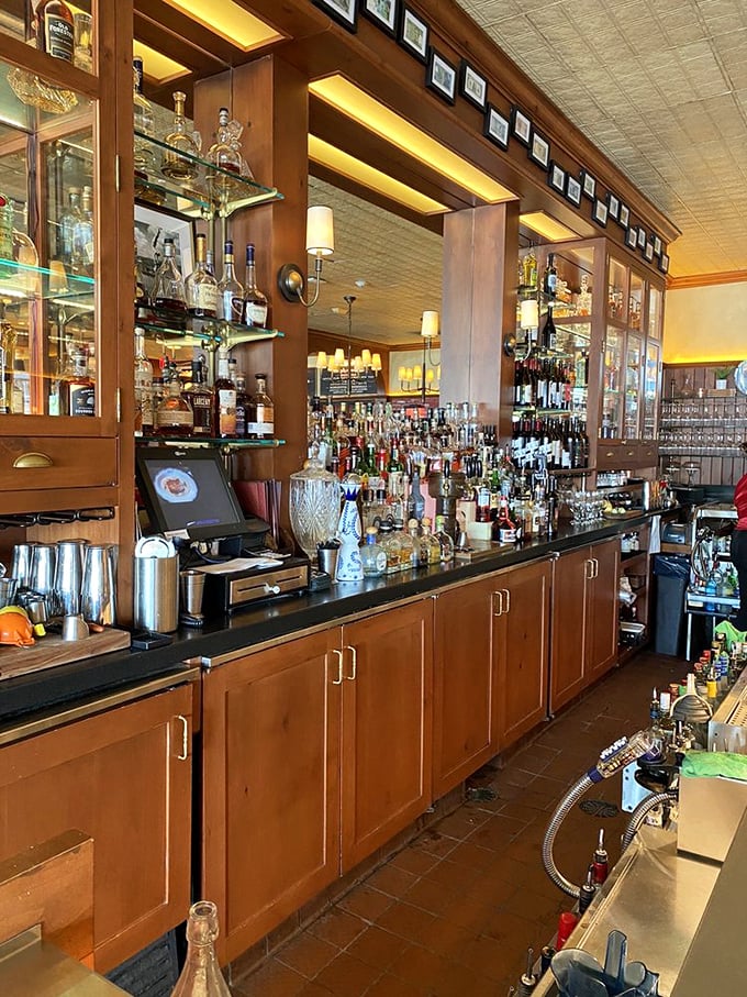 A bar that understands priorities – enough bottles to solve any problem, arranged with the precision of a scientific laboratory.