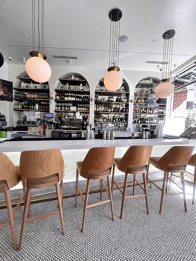 The bar area invites you to perch, sip, and contemplate life's important questions—like "Can I try all the cocktails in one visit?"