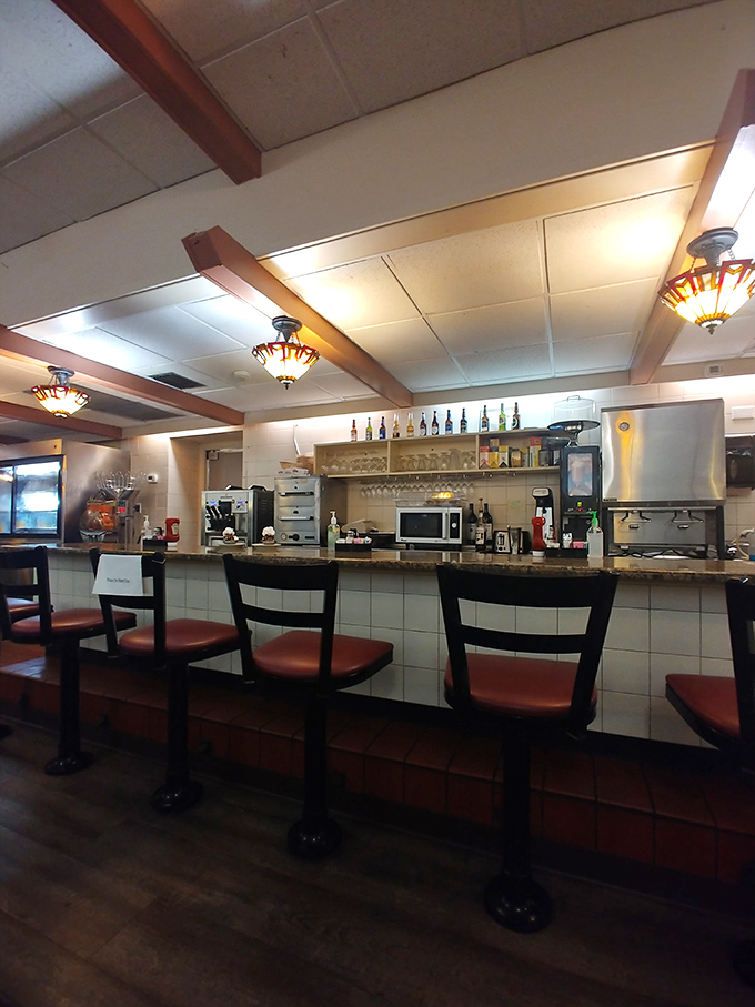 The counter seating offers front-row views of the kitchen action – where breakfast dreams become reality without any unnecessary culinary theatrics.