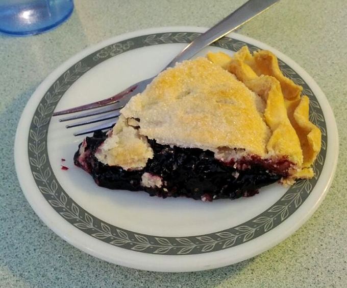 A slice of black raspberry pie that makes you wonder why people waste time with birthday cake when this exists in the world.
