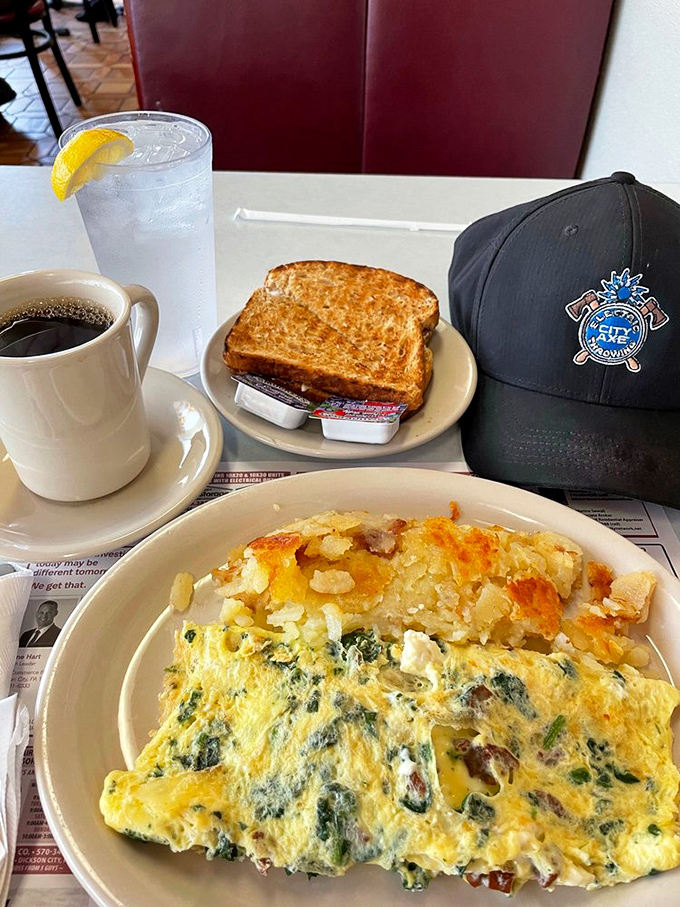 Morning glory on a plate—a spinach and cheese omelet that makes vegetables feel like an indulgence. That perfectly golden toast is ready for its supporting role.