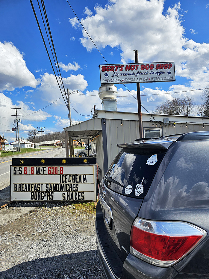 The sign announces operating hours like a promise – these are the golden times when happiness is served in paper wrappers.