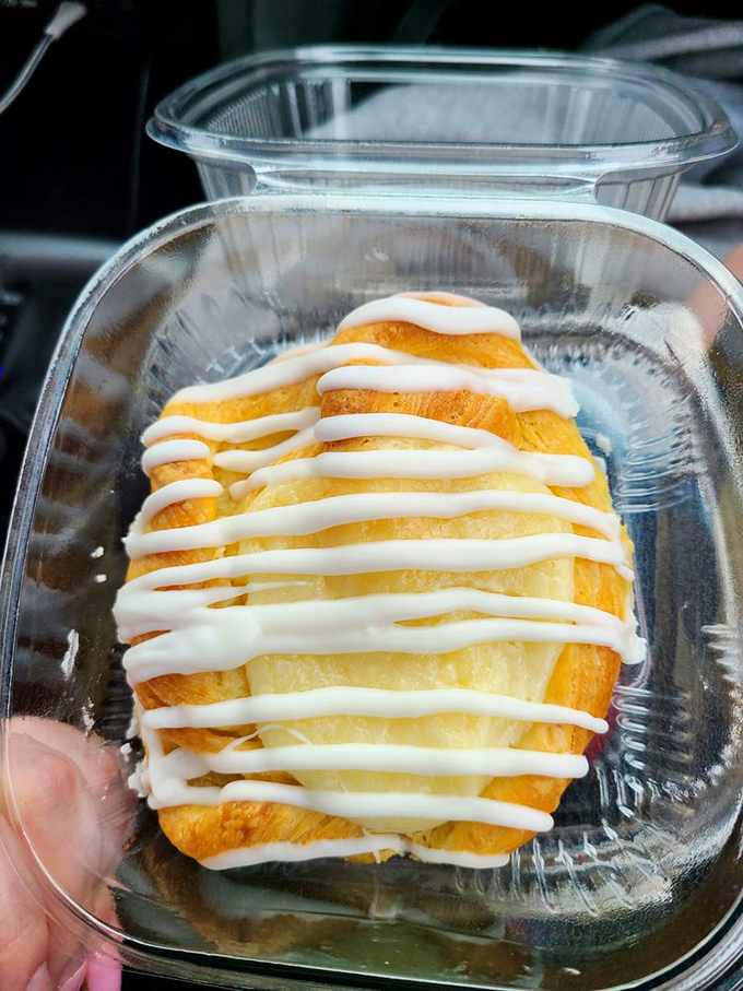 A danish that deserves its own Instagram account—layers of pastry cradling what appears to be cream cheese frosting in perfect harmony.