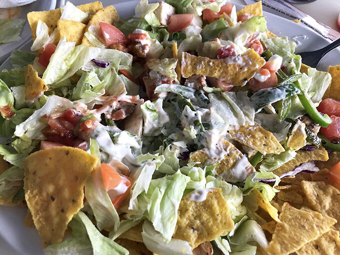 A salad that doesn't apologize for being delicious. Those tortilla strips aren't just garnish—they're essential crunch architecture.