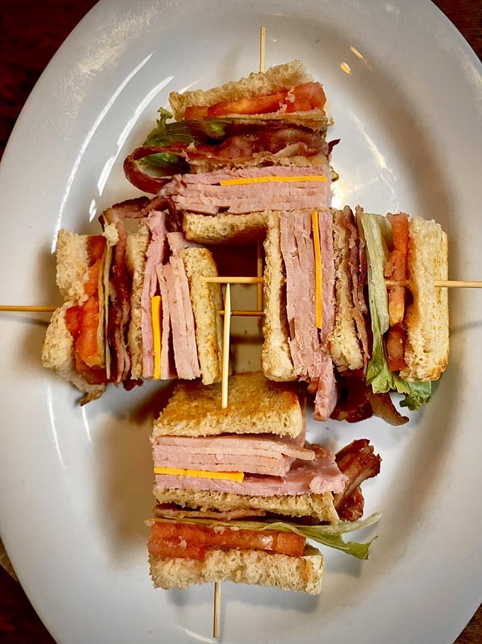 This club sandwich isn't stacked—it's architecturally engineered for maximum flavor in every skewered section. Sandwich geometry at its finest.