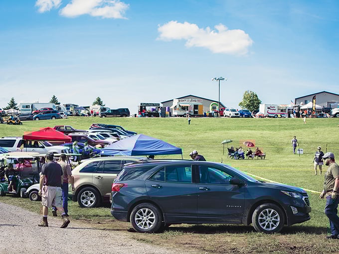Community gathering in full swing – where lawn chairs and pop-up tents create a temporary neighborhood united by whatever's happening at the far end of that field.