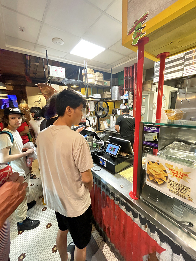 Where the magic happens—customers eagerly place orders at the counter while staff prepare fresh Mexican delights just feet away.